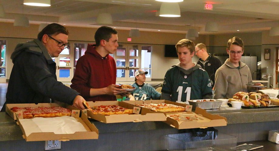 Parish draws 35 men, sons for theology talk via football party ...