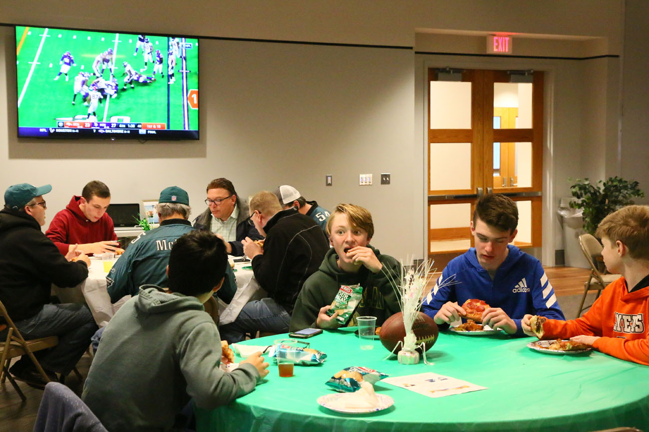 Parish draws 35 men, sons for theology talk via football party ...