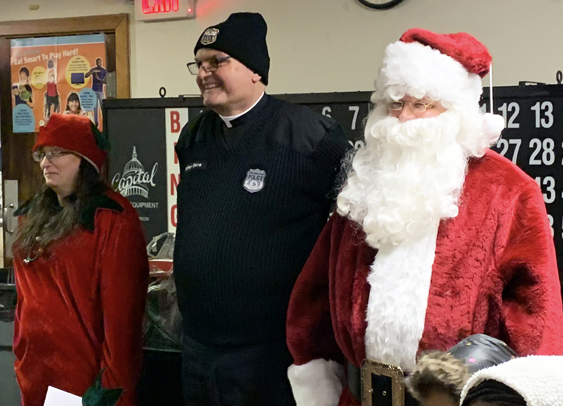 Santa, priest and police 'raise a holiday ruckus' for archdiocesan ...